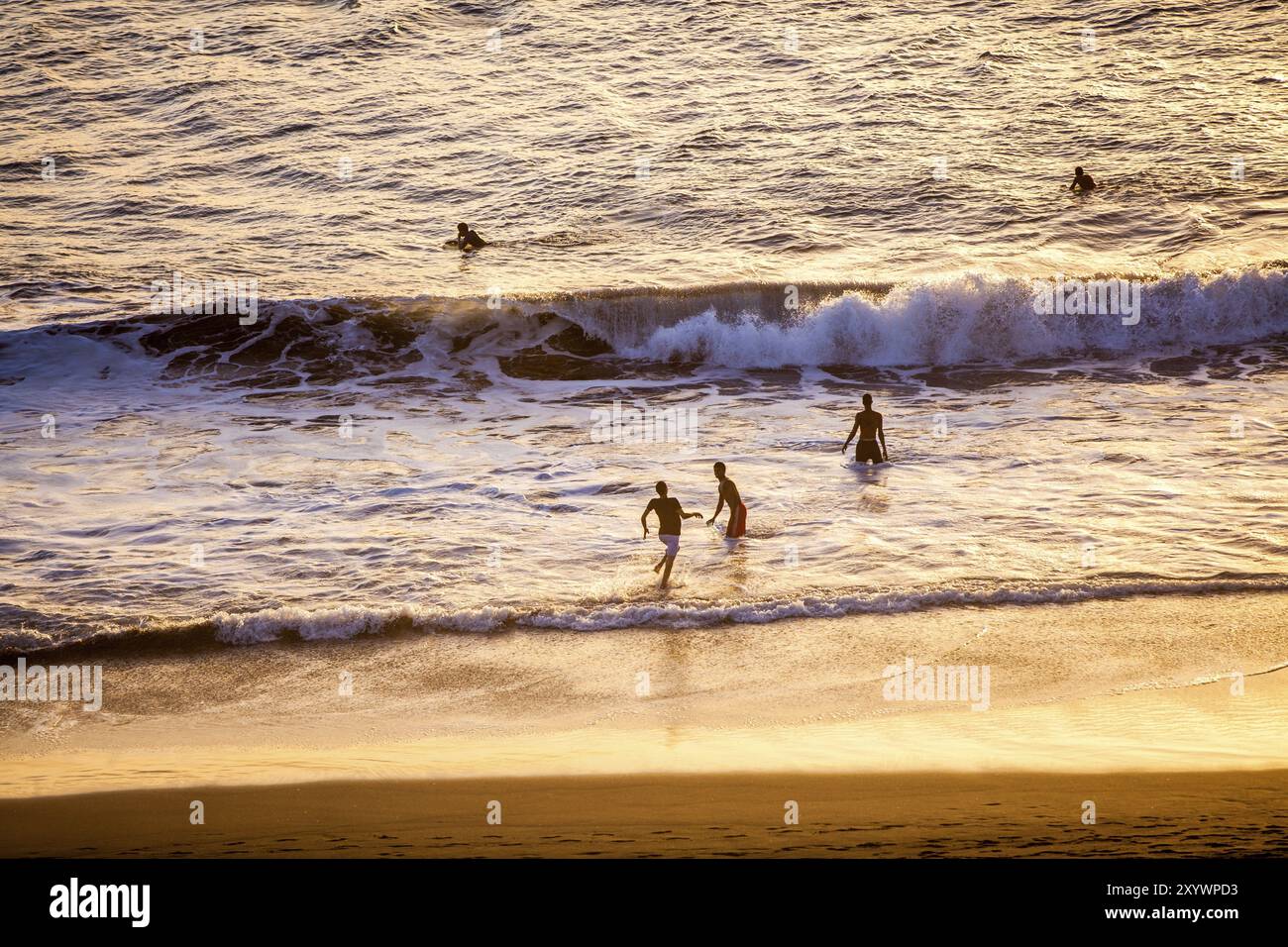A group of young men having fun on the beach Stock Photo - Alamy