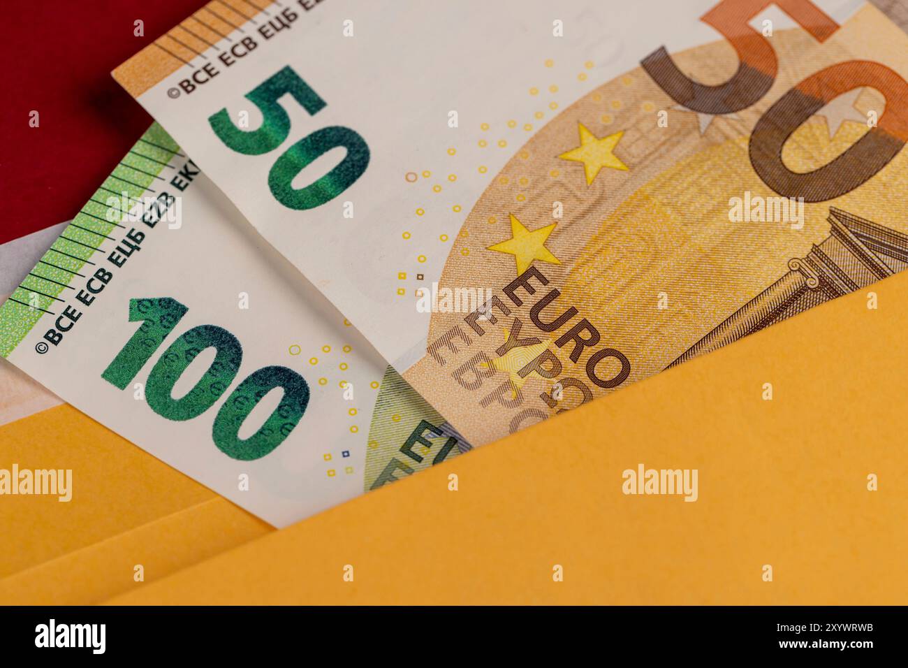 yellow paper envelopes with euro cash, folded into a paper envelope of ...