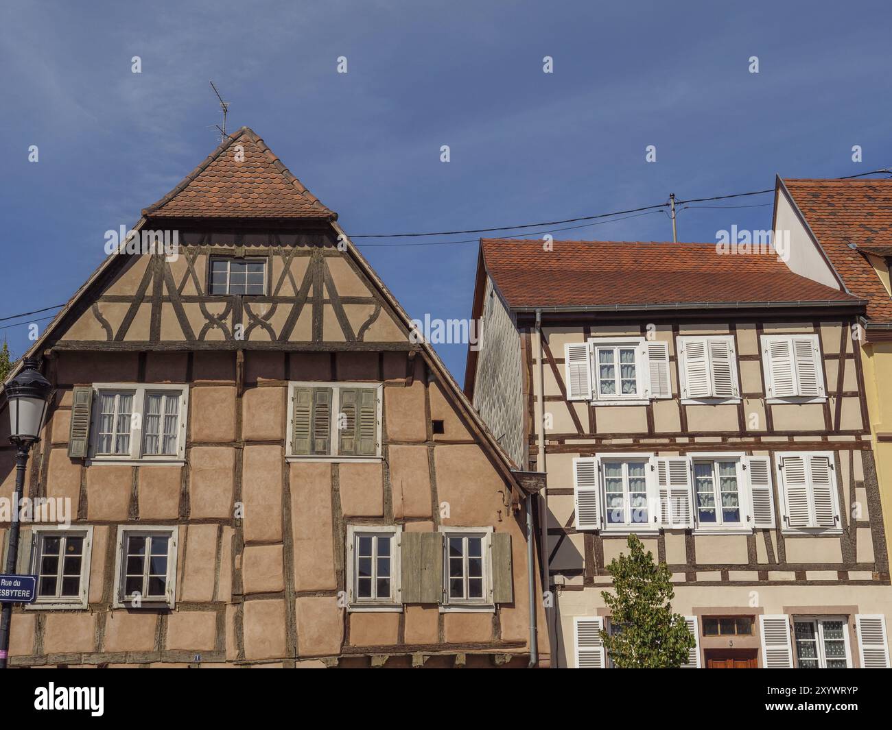 Two half-timbered houses in traditional style, under a clear blue sky ...