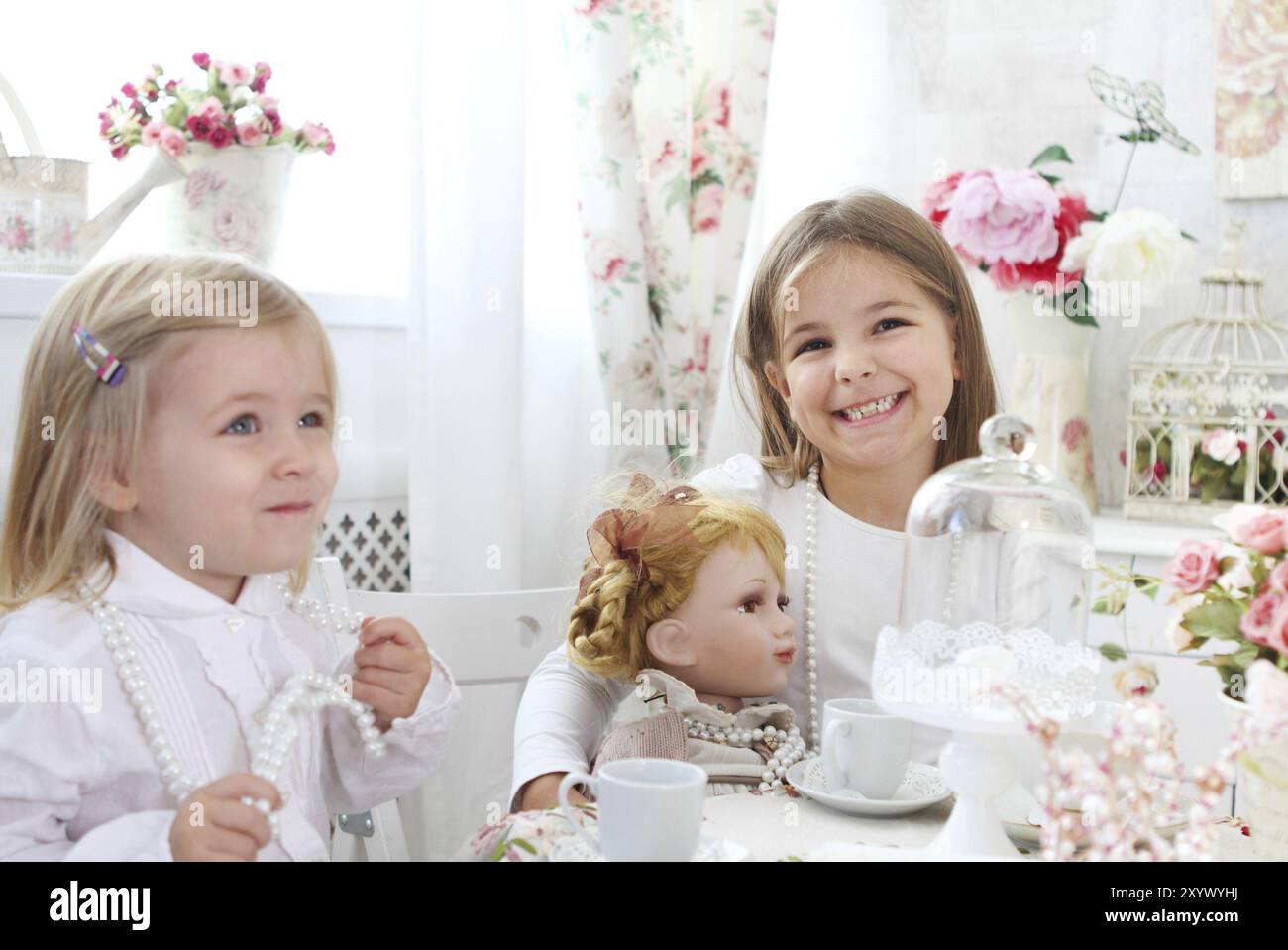 Two little cute sisters playing at tea parties Stock Photo - Alamy