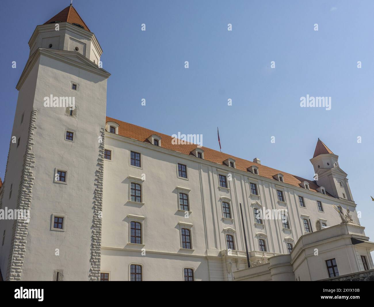 Side view of a large historic castle building with towers against a ...