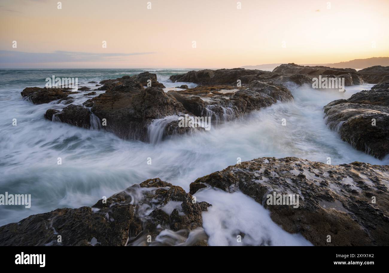 Waves washing over rocks by the sea, long exposure, coastal landscape ...
