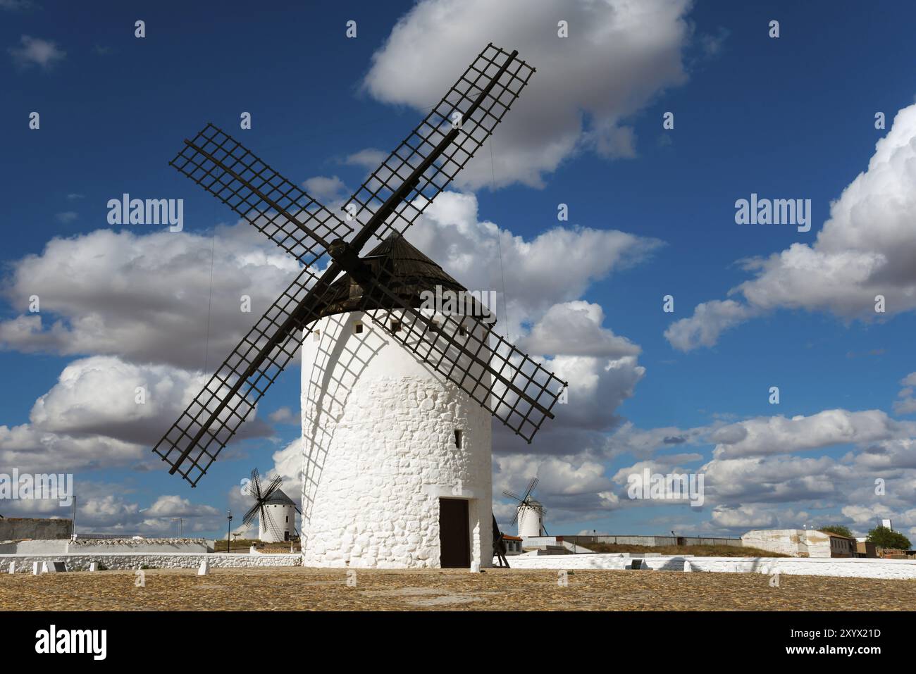 Historic white windmill under a blue sky with clouds and sunny ...