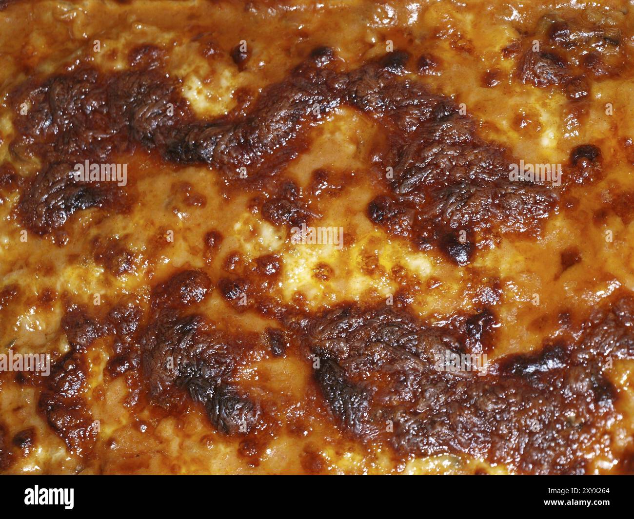 Closeup of melted cheese, brown and crusty Stock Photo - Alamy