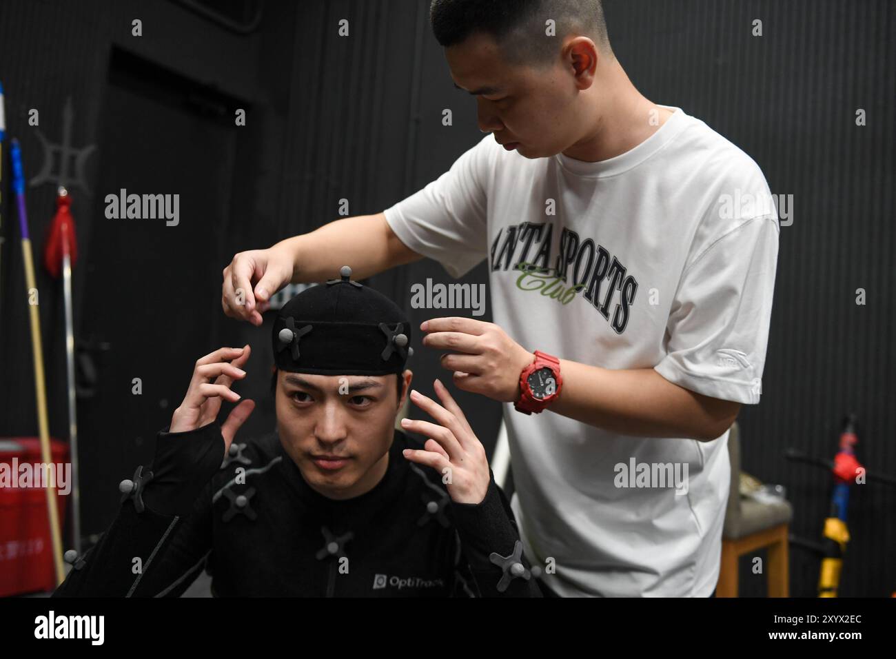 (240831) -- SHENZHEN, Aug. 31, 2024 (Xinhua) -- A crew member adjusts the motion capture devices ...