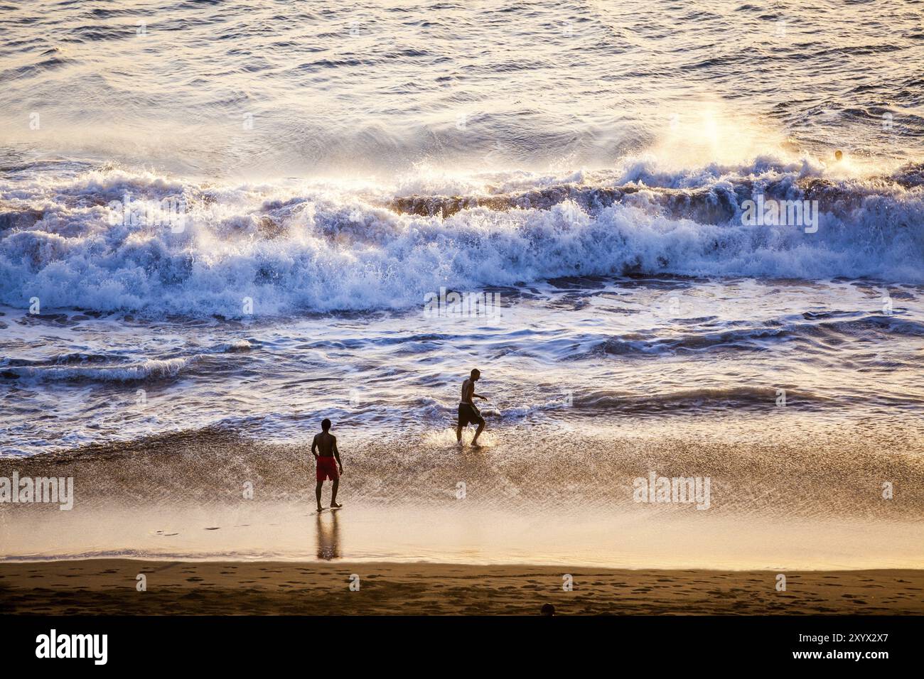 A group of young men having fun on the beach Stock Photo - Alamy