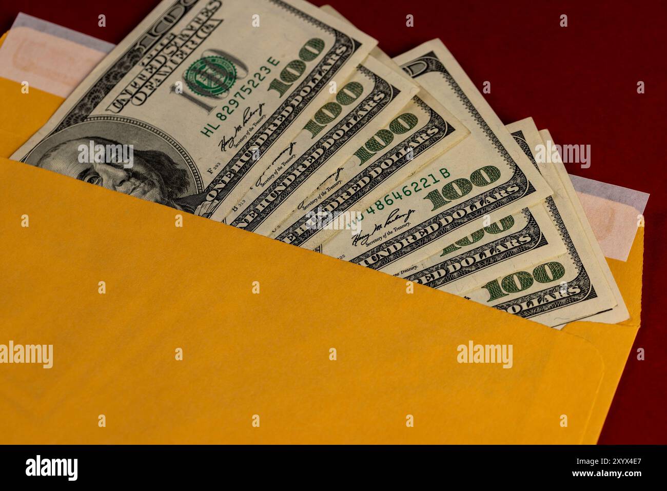 new yellow paper envelopes with American dollars, folded American 100 ...