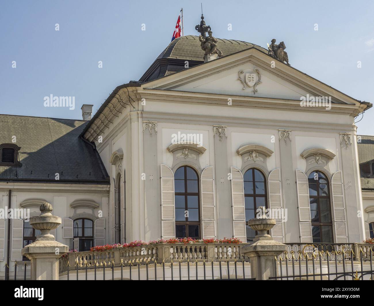 Facade of a historic building with large windows and blue sky ...