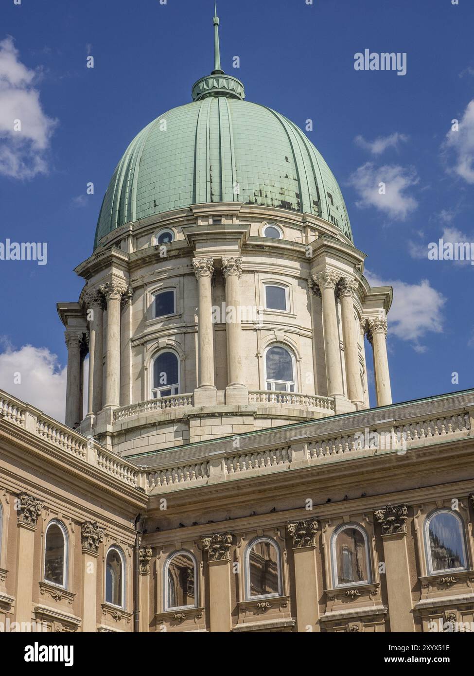 The green dome of a castle towers over a historic facade with many ...