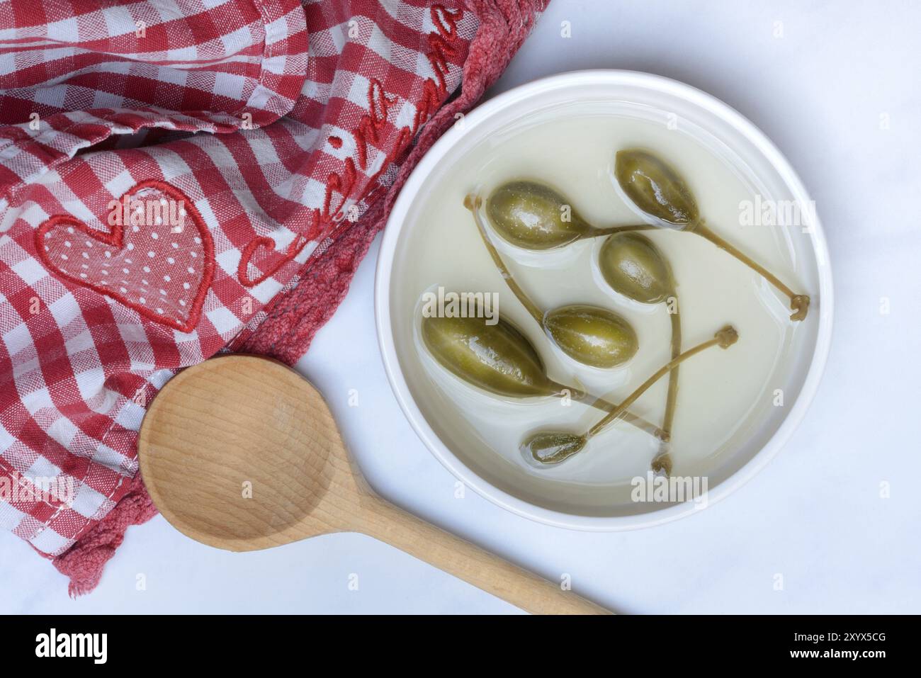 Caper apples in skin and cooking spoon, caper, caper fruit, Capparis ...