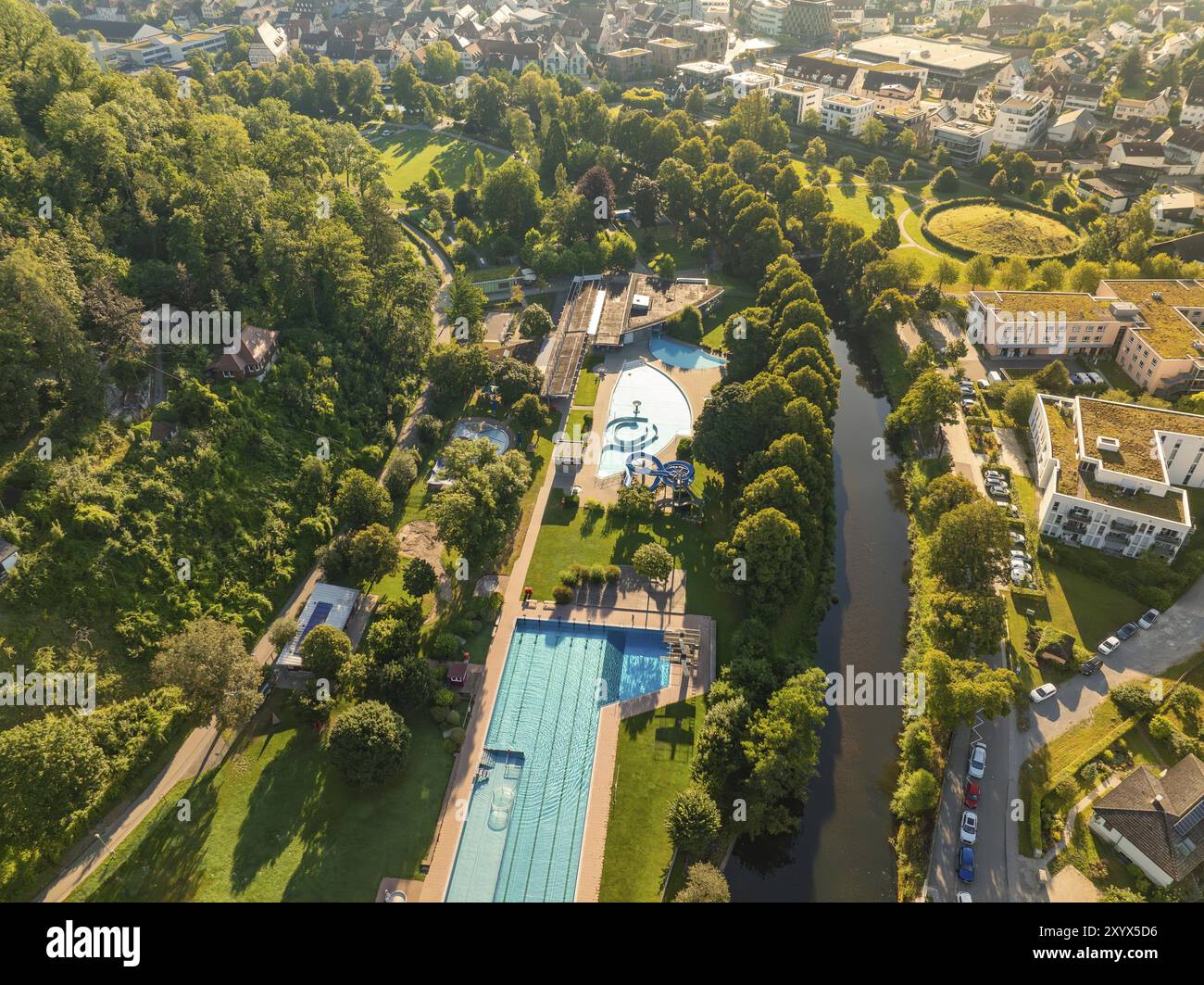 Outdoor pool complex with large swimming pools and surrounding green ...