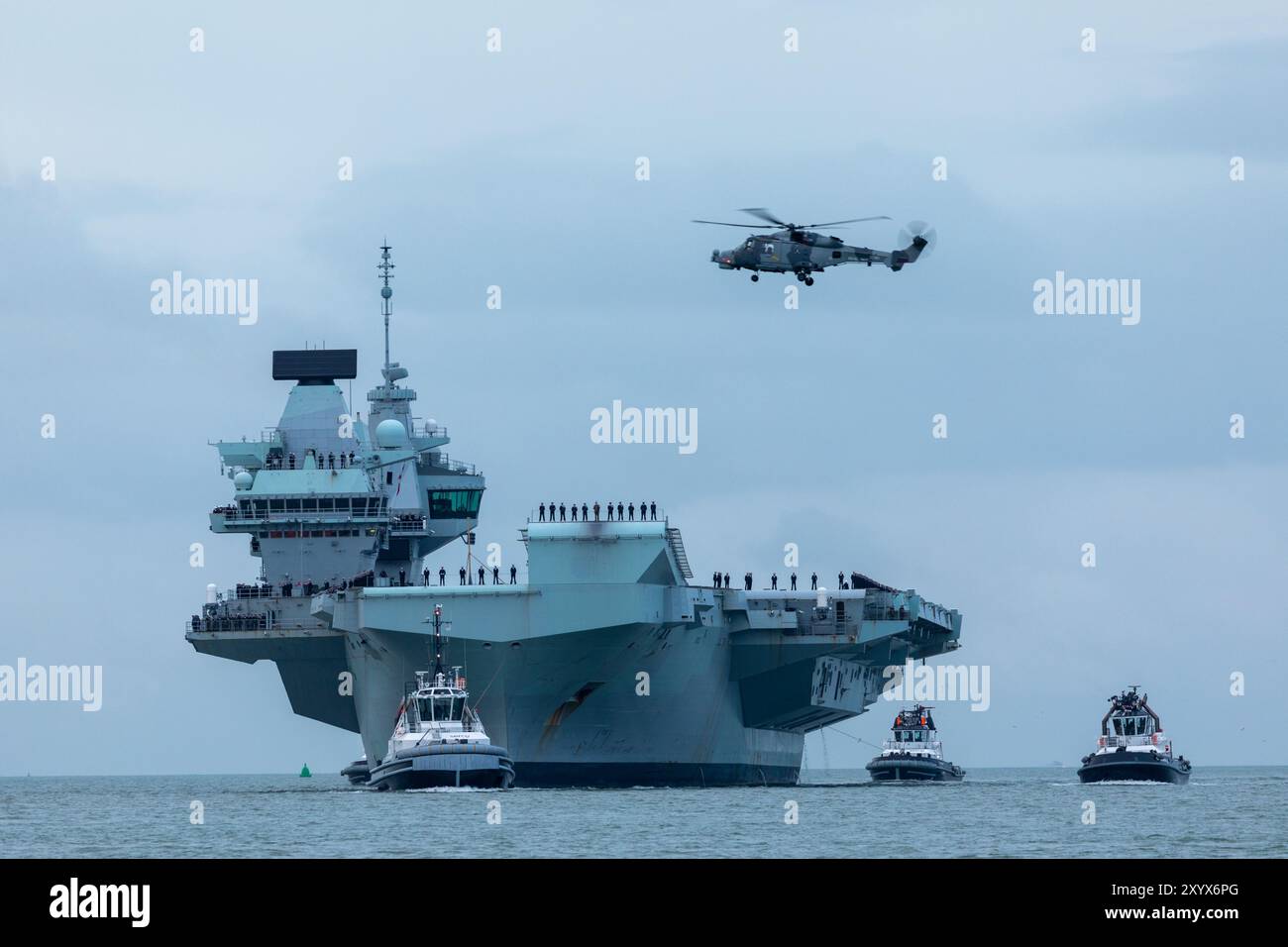 HMS Queen Elizabeth head on as it enters the Solent. Over head a ...