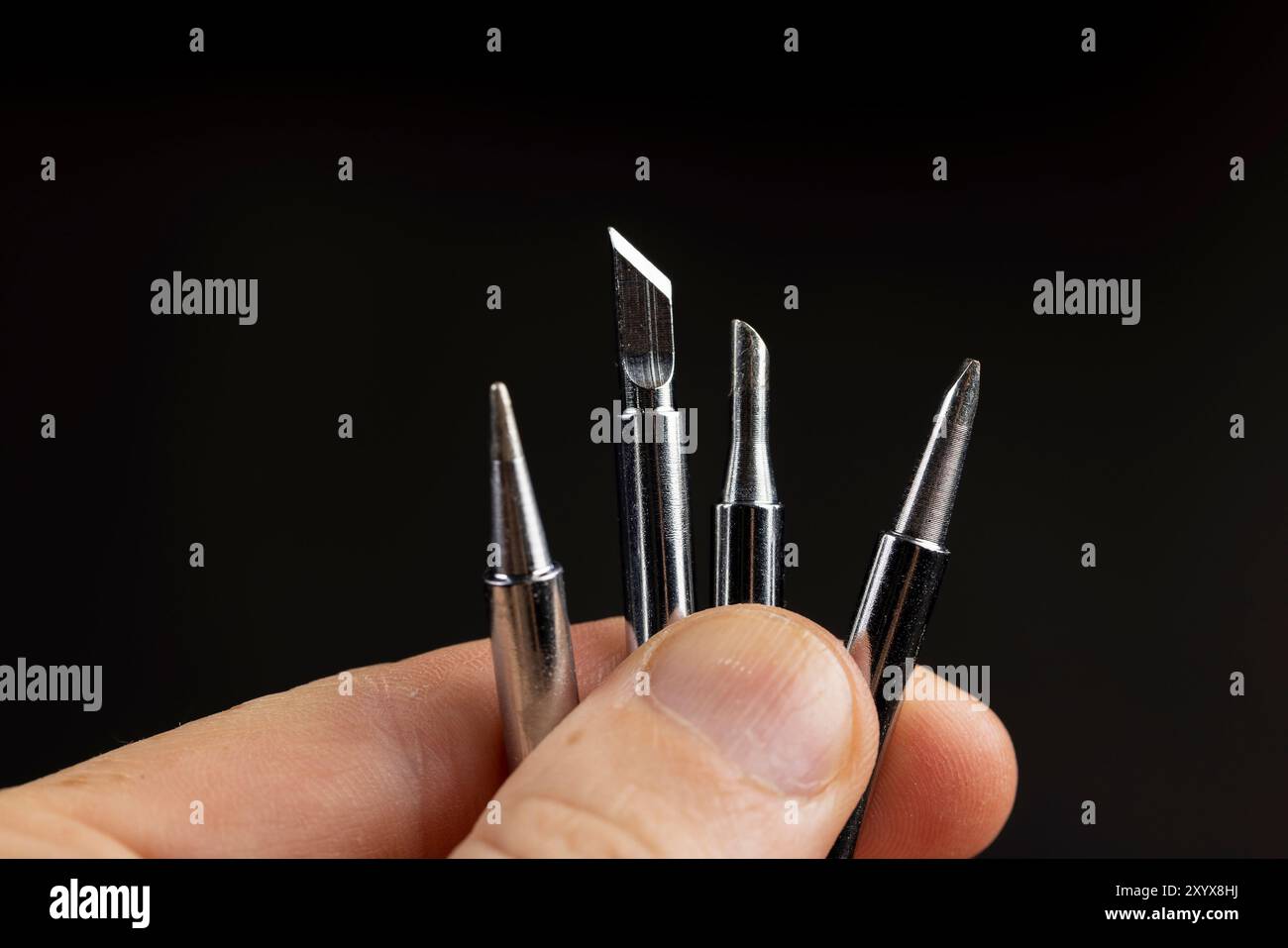 thin and soft solder and soldering iron tips, twisted as a spring ...