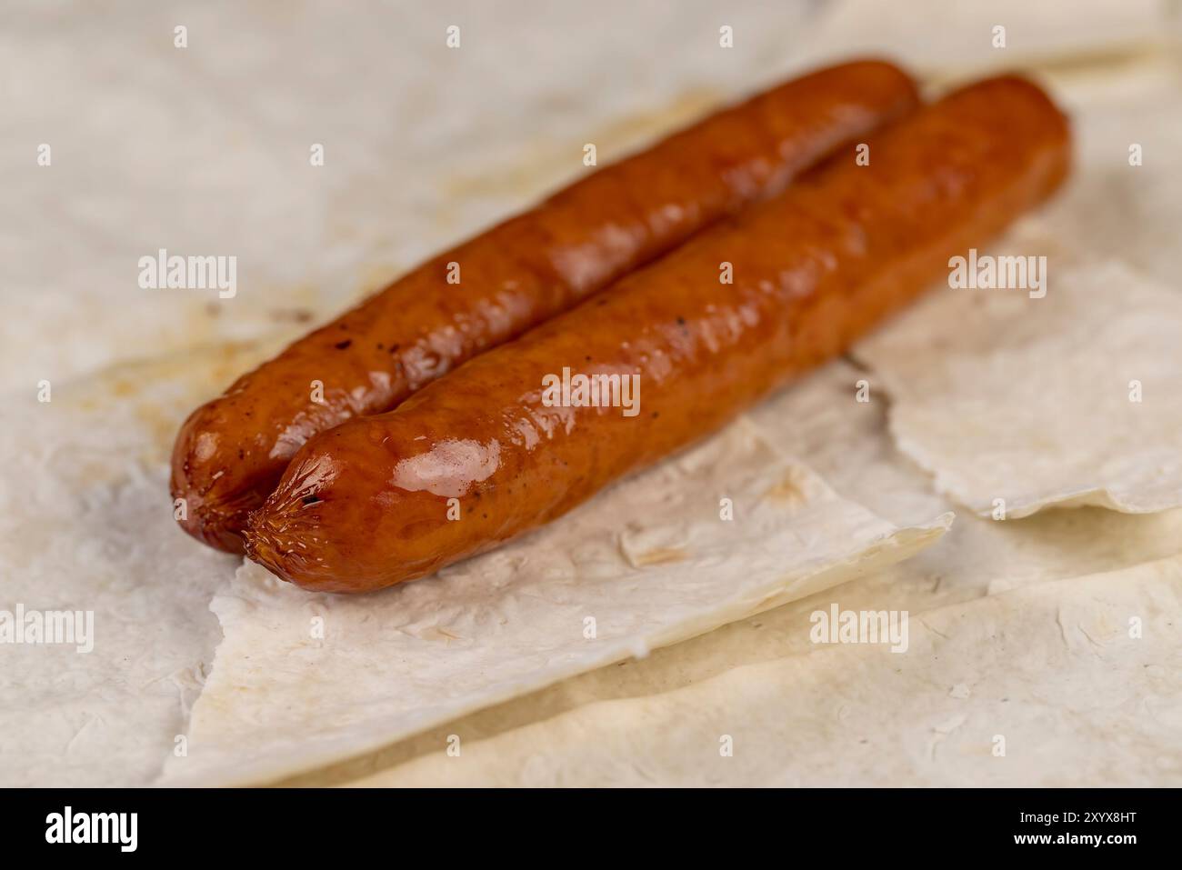 inverted sausages lying on wheat pita bread, cooked pork sausages on ...