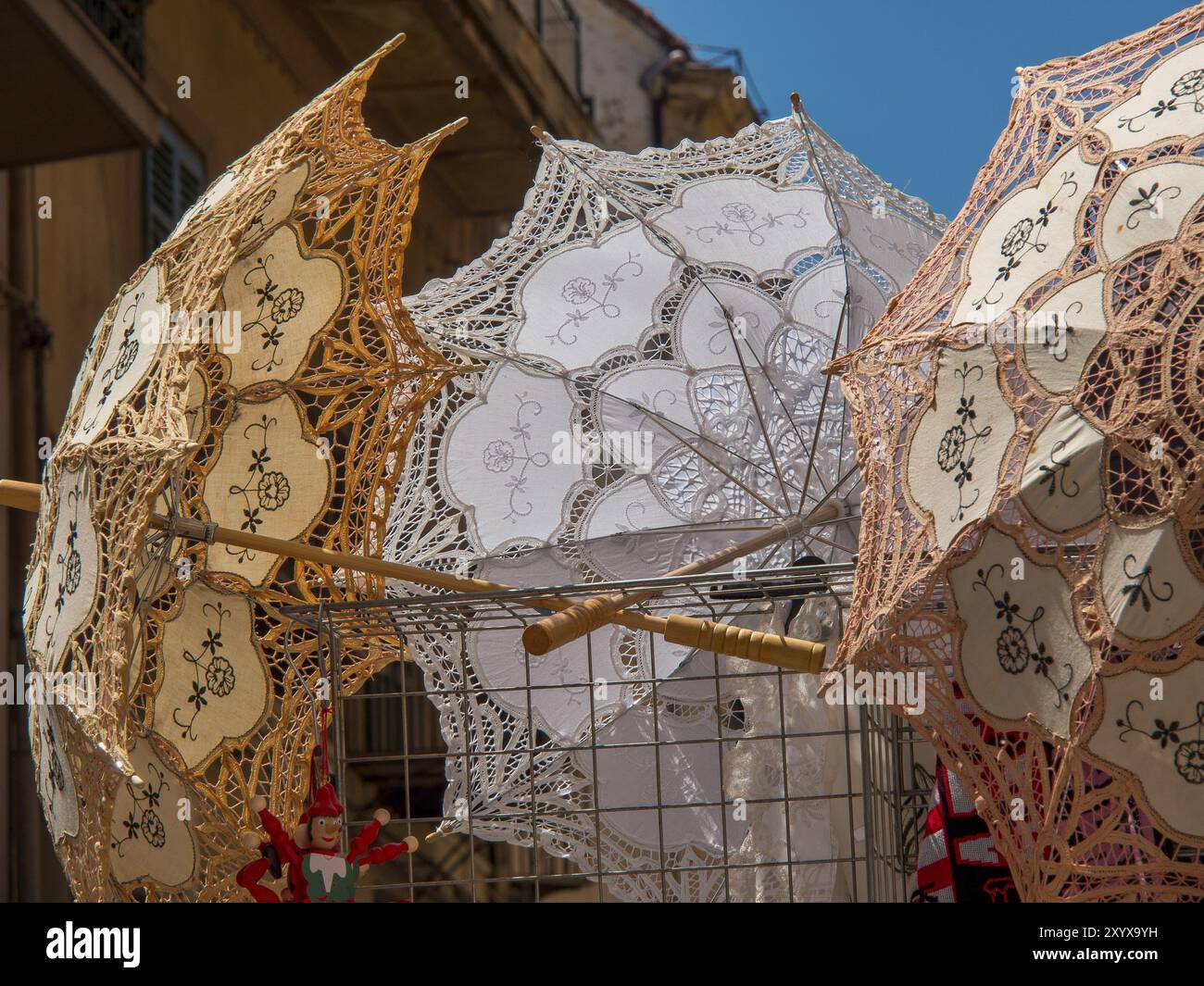 Decorative lace umbrellas in different patterns and colours hanging on ...