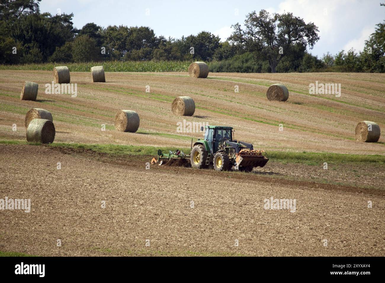 Tractor rolling hay field hi-res stock photography and images - Alamy