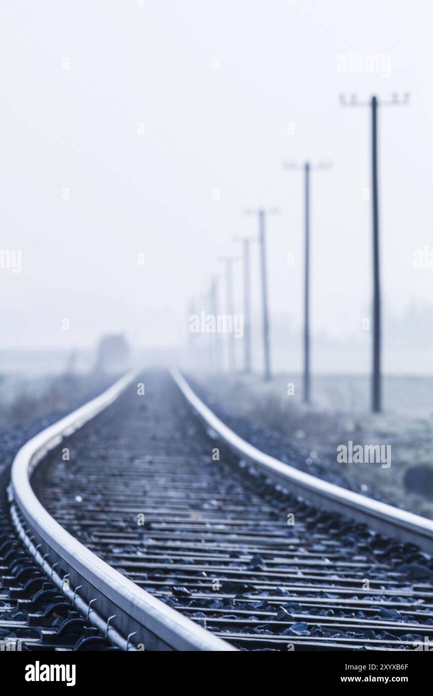 Single-track railway line in the morning fog Stock Photo - Alamy