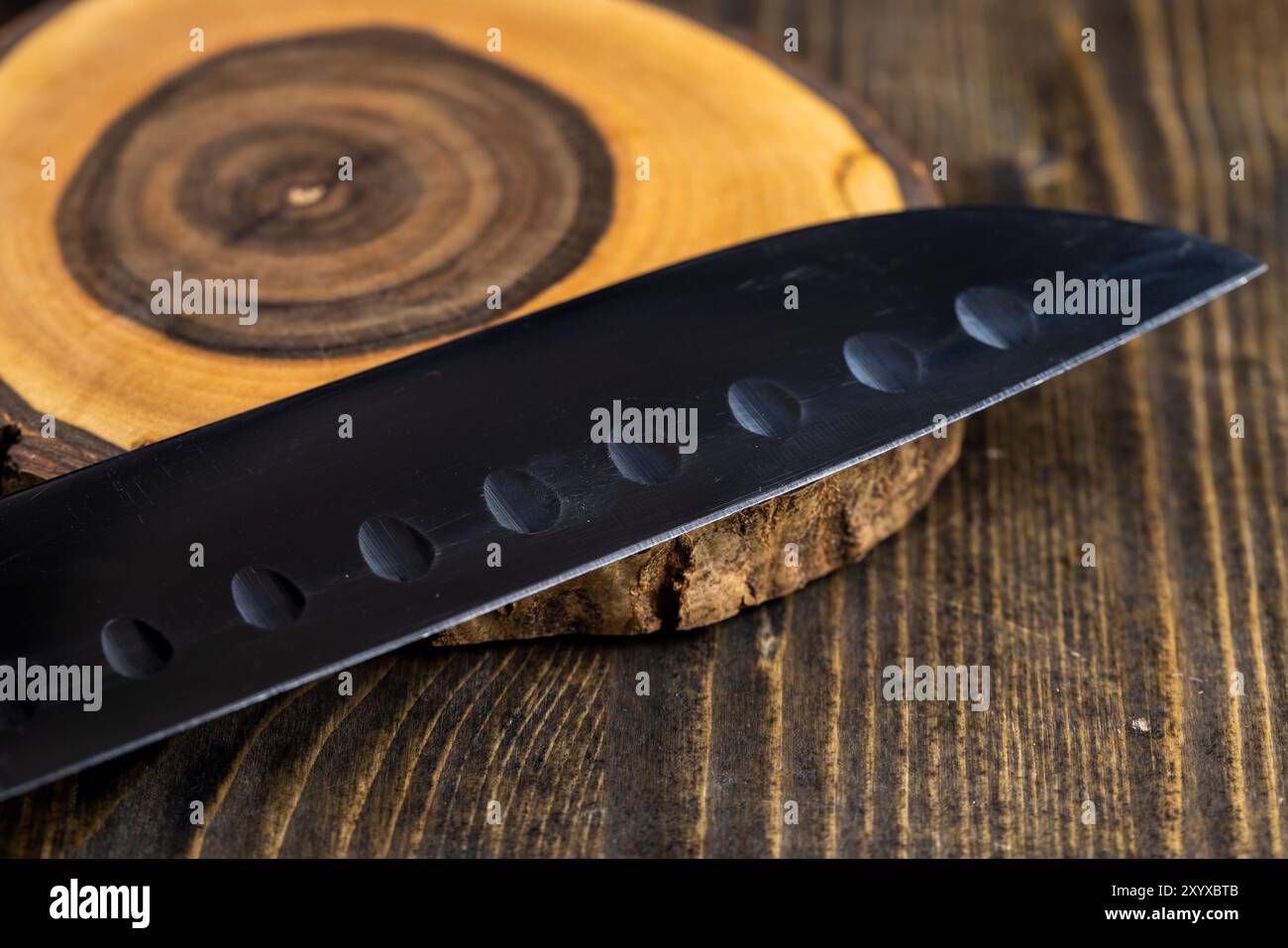 knife covered with water droplets on a blackboard background, a wet ...