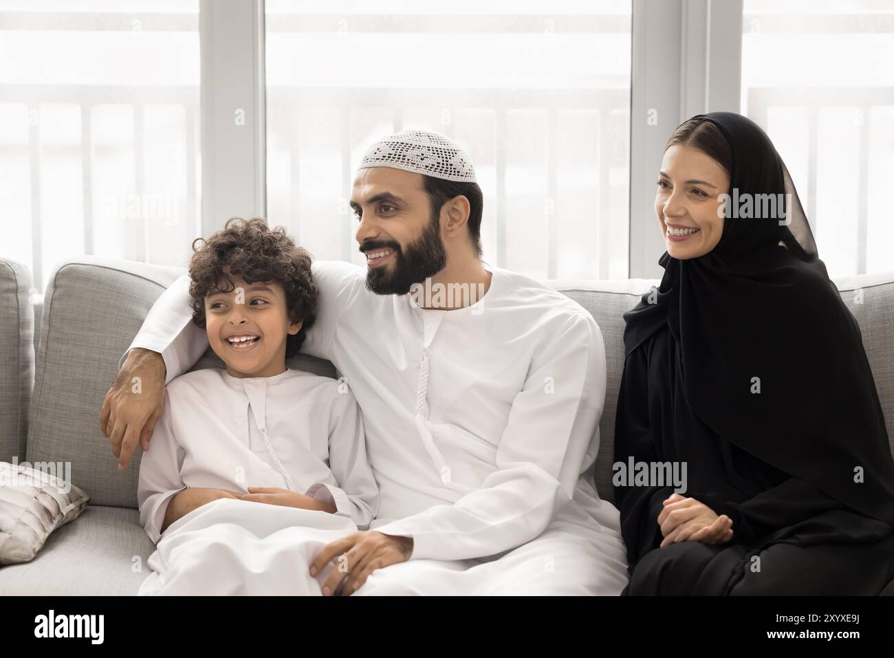 Happy Arabian parents hugging cute son boy Stock Photo - Alamy