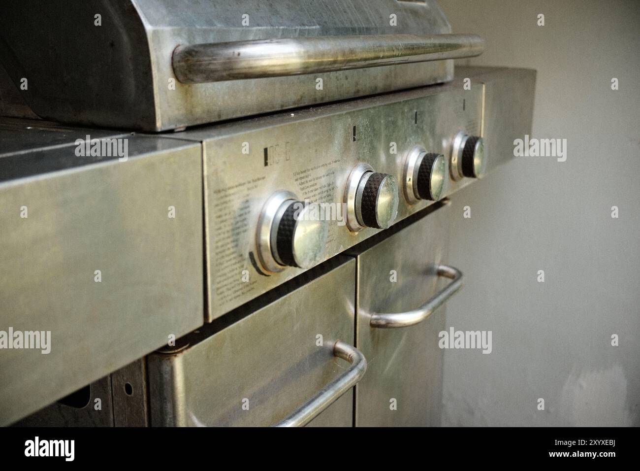 Details of the control knobs and grill body of an outdoor stainless ...