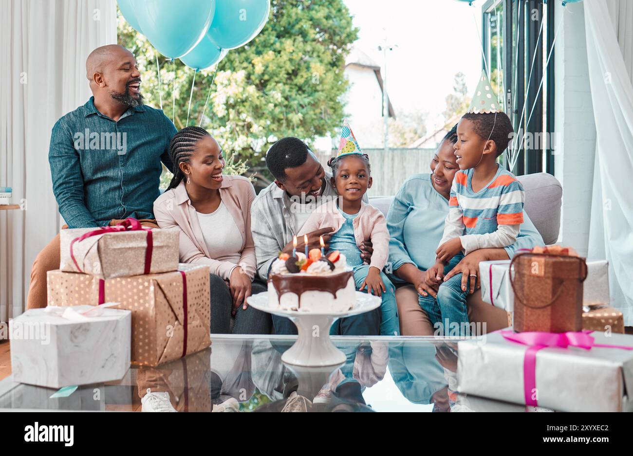 Birthday cake, gifts and portrait of black child with family at party ...
