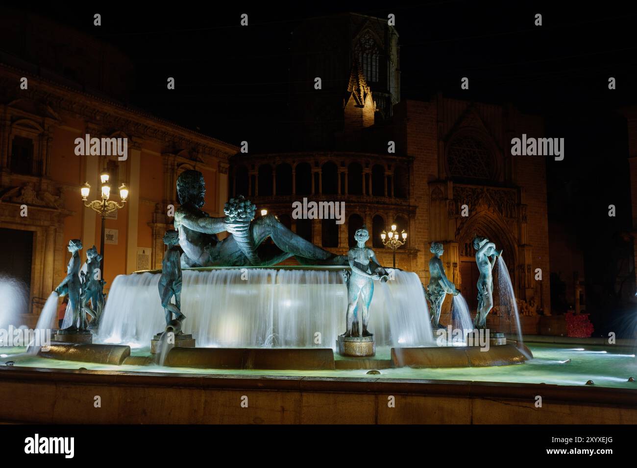 Illuminated statue fountain and historical architecture backdrop Stock ...