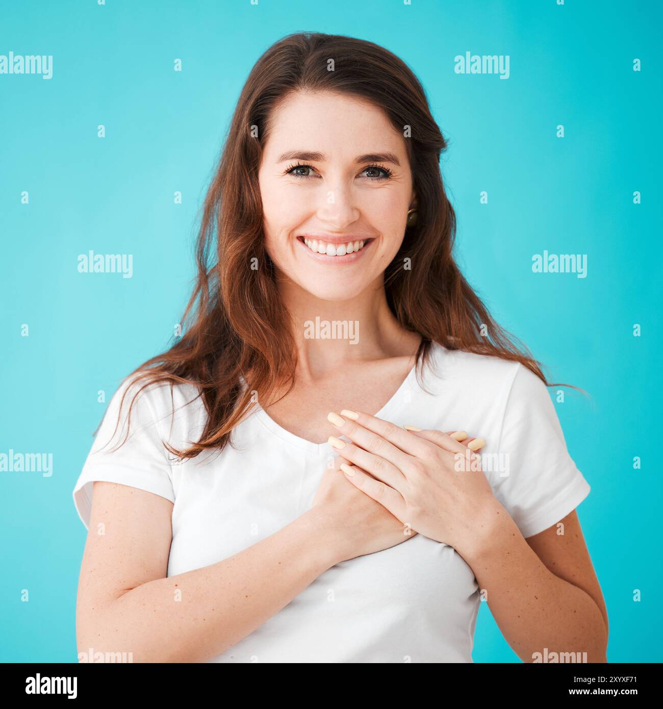 Woman, portrait and hands on chest in studio for thank you, kindness ...