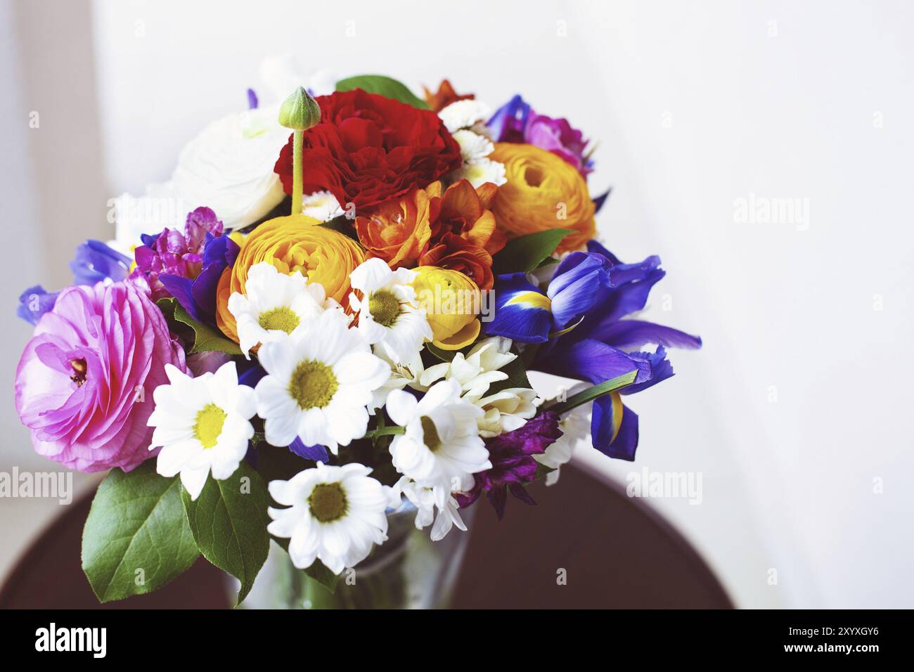 Unusual bright wedding bouquet with ranunculus, roses and irises Stock ...