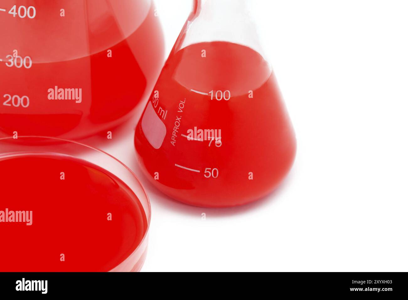 Laboratory glasswear with red chemical solutions on white Stock Photo ...