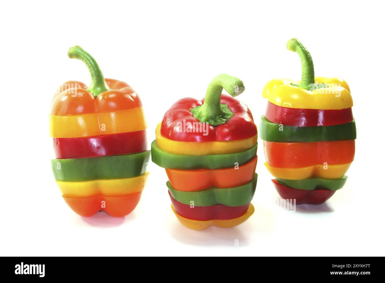 Different coloured peppers layered on a white background Stock Photo ...
