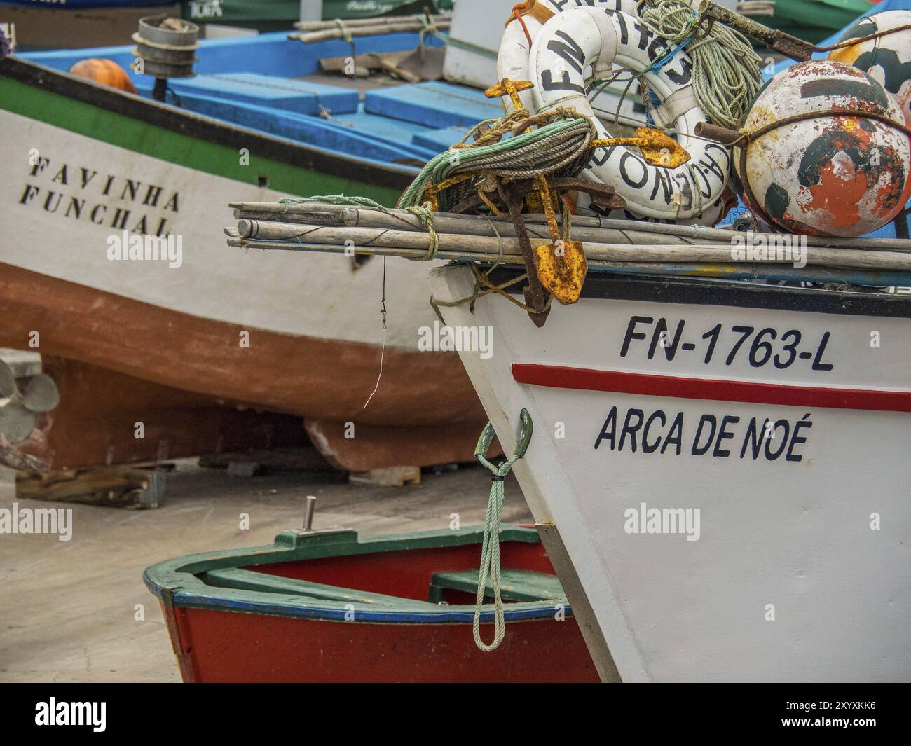 Boats in the harbour, one equipped with the name Arca de Noe, lifebuoys ...