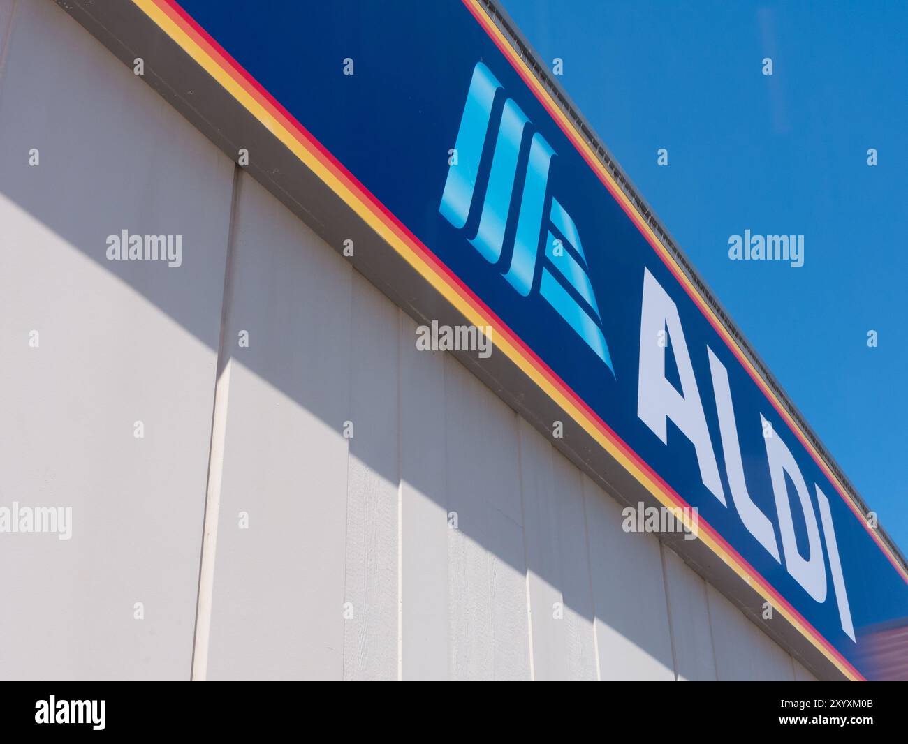 Close up of signage on Aldi supermarket on a sunny with blue sky in ...