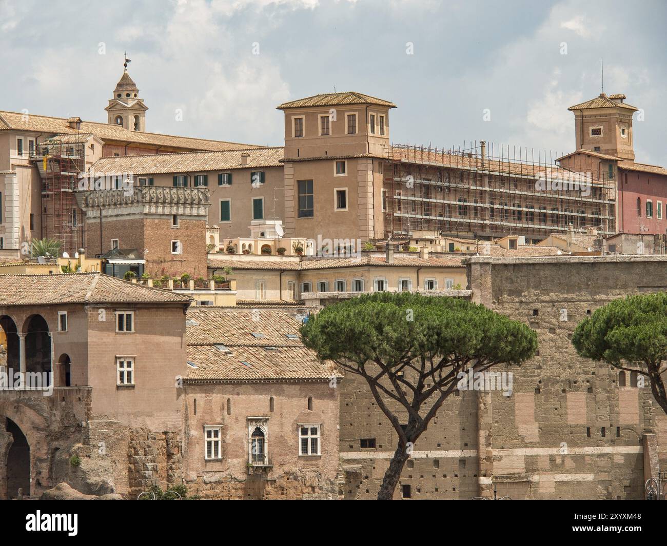 Ancient Roman buildings with pine trees in front and clouds in the sky ...