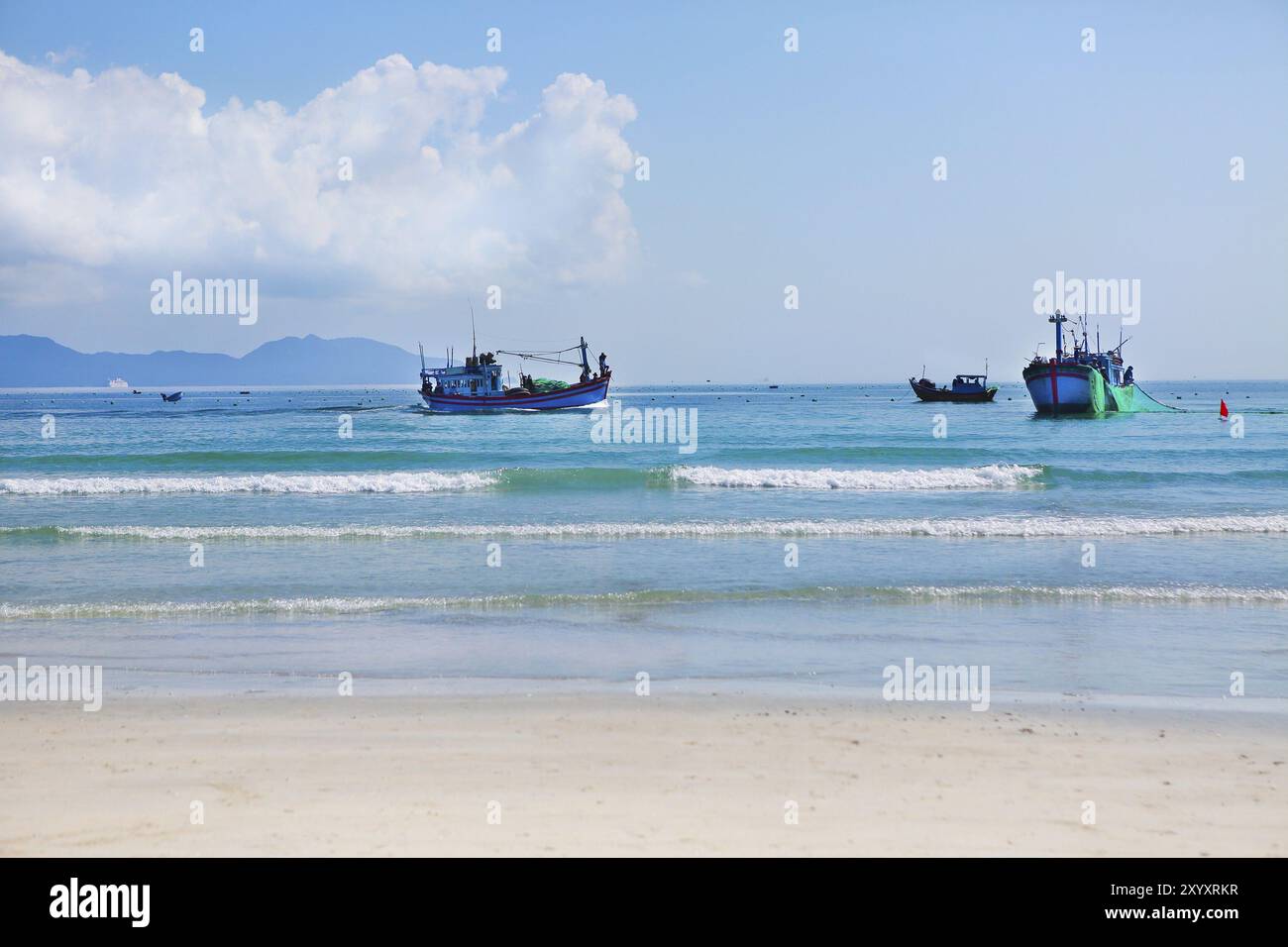 Boats on the Zoklet beach. Vietnam landscape. Sand beach and sea waves ...
