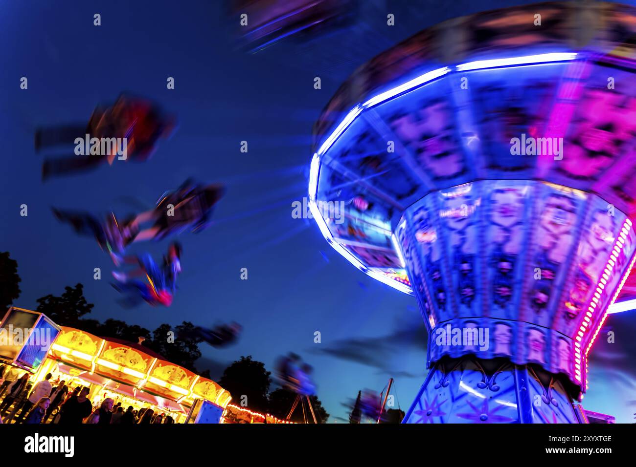 Traditional chain carousel at night Stock Photo - Alamy
