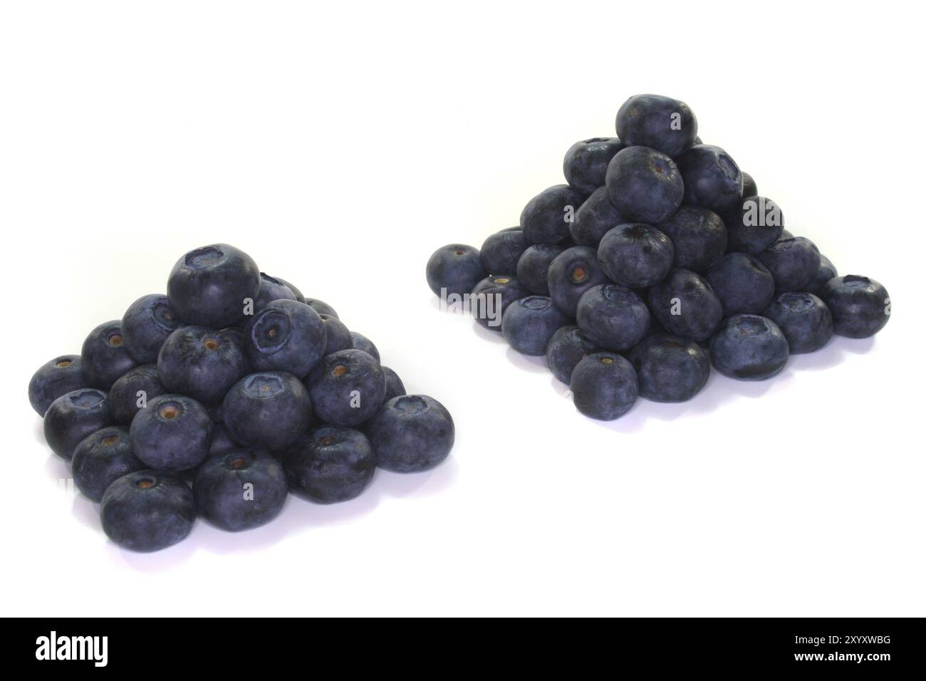 Two pyramids of fresh blueberries on a white background Stock Photo - Alamy