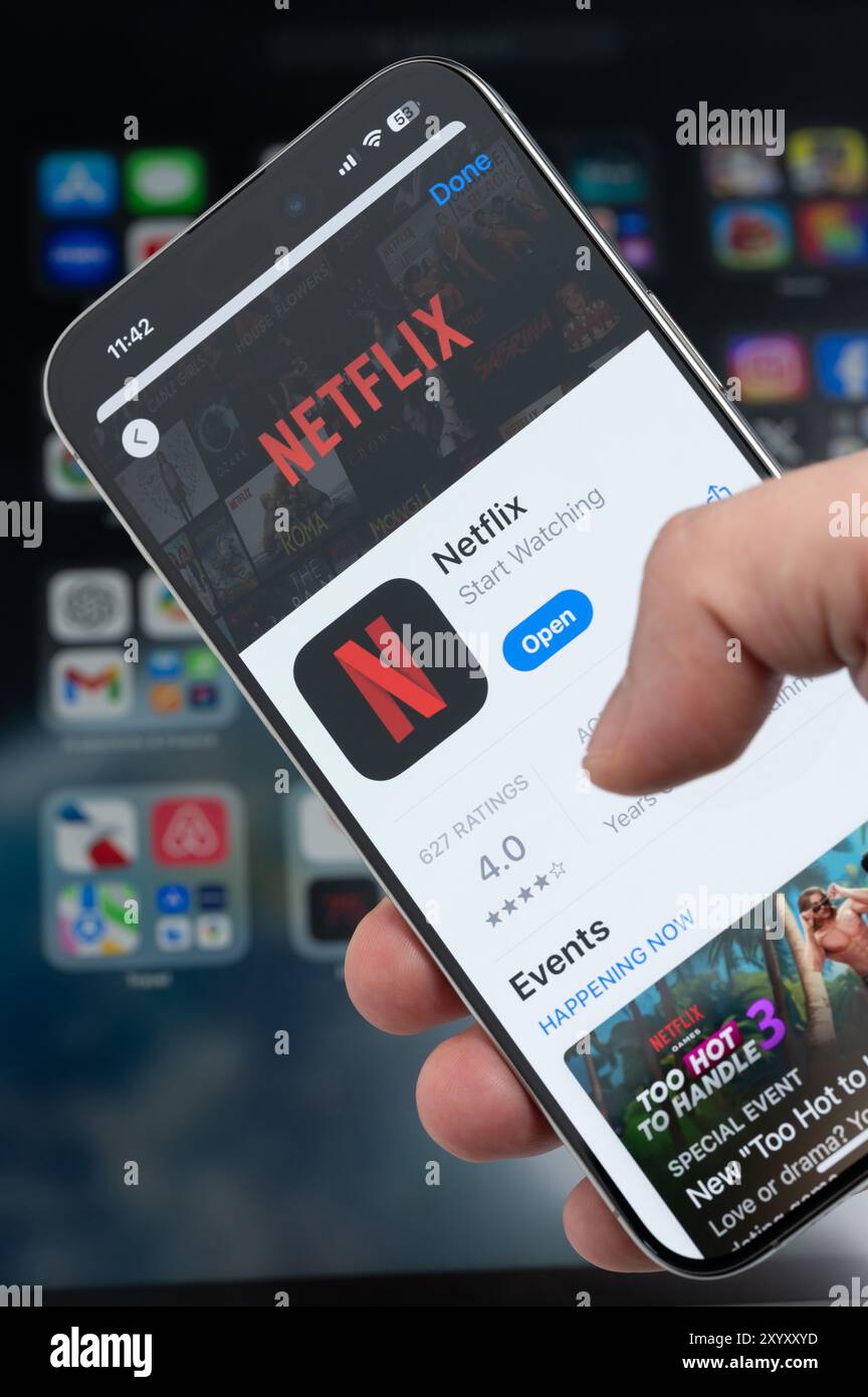 New York, USA - August 5, 2024: Smartphone in hand with Netflix app on screen macro close up ...