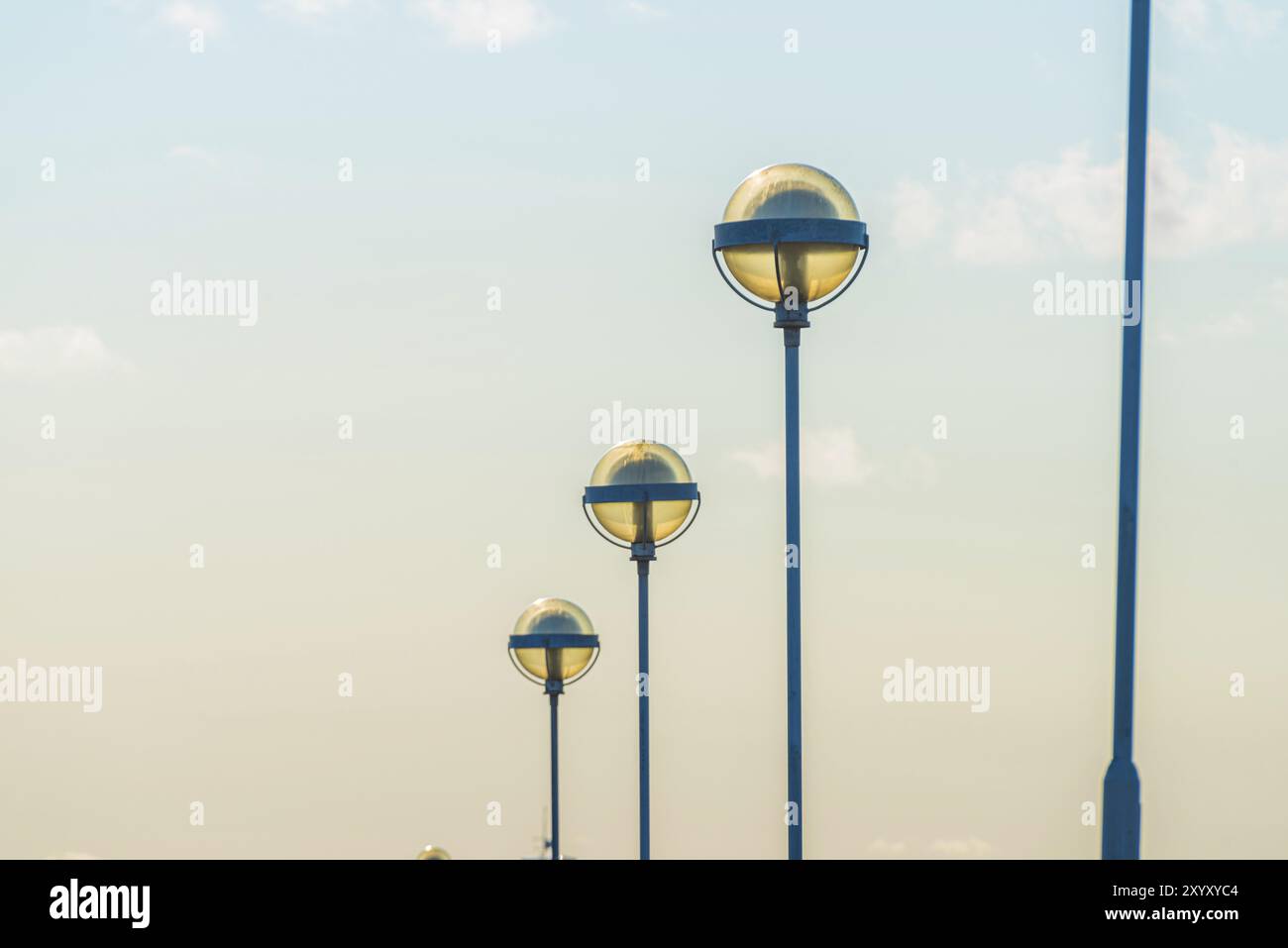 Lamp posts in a row at sunlight Stock Photo - Alamy