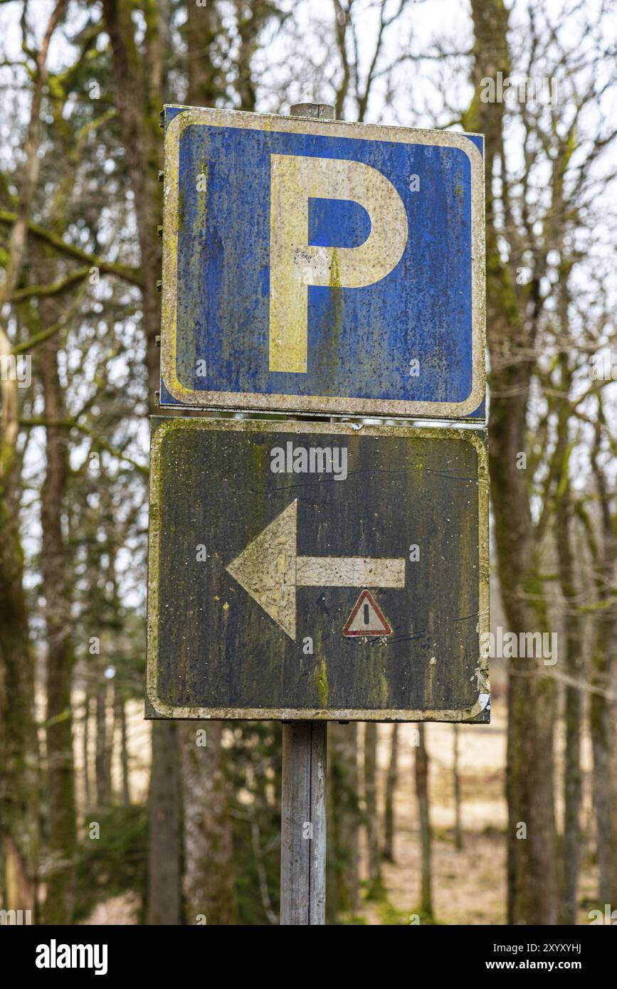 Old and mossy parking sign Stock Photo - Alamy