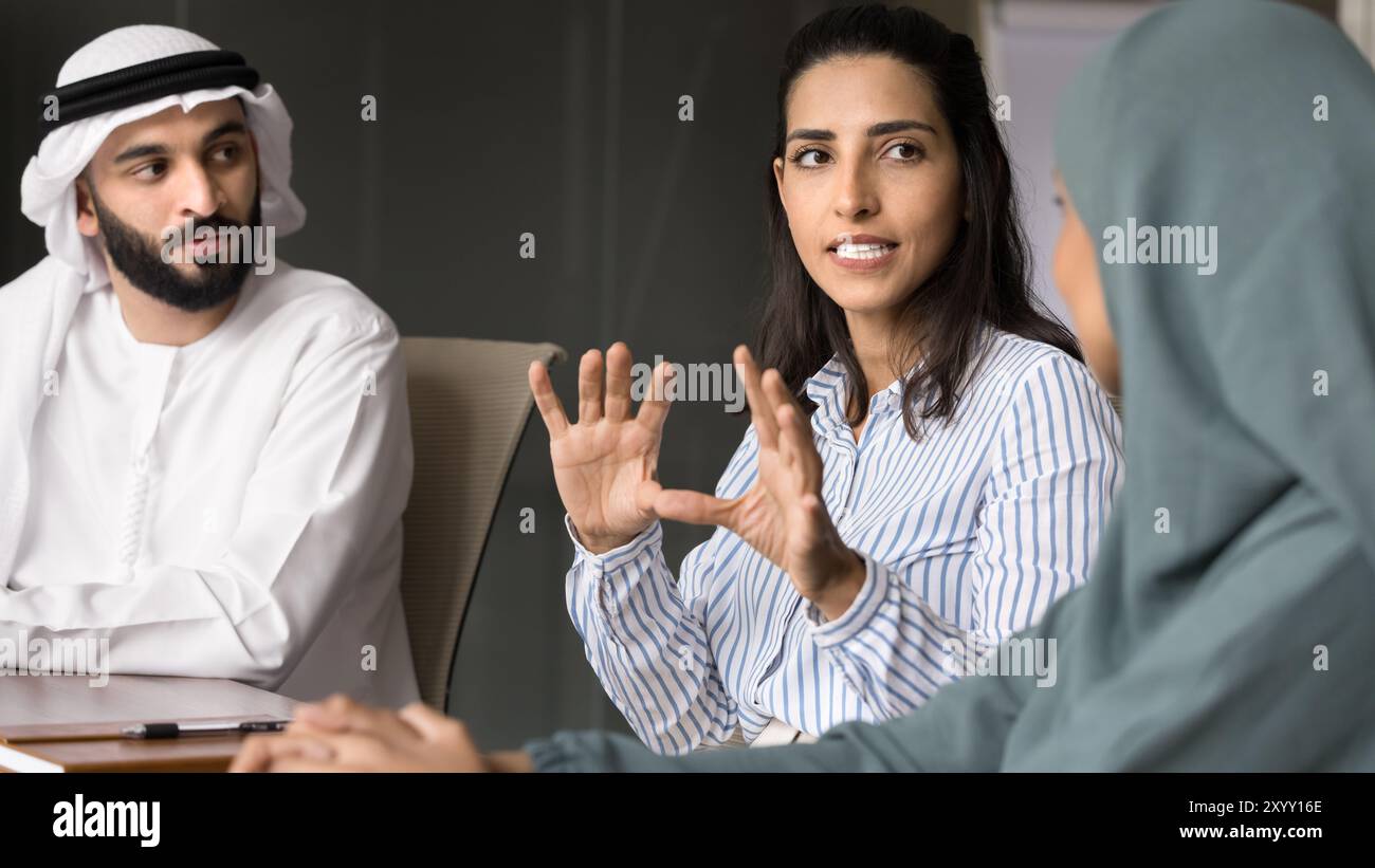 Inspired motivated Hispanic business woman talking to Arabian ...