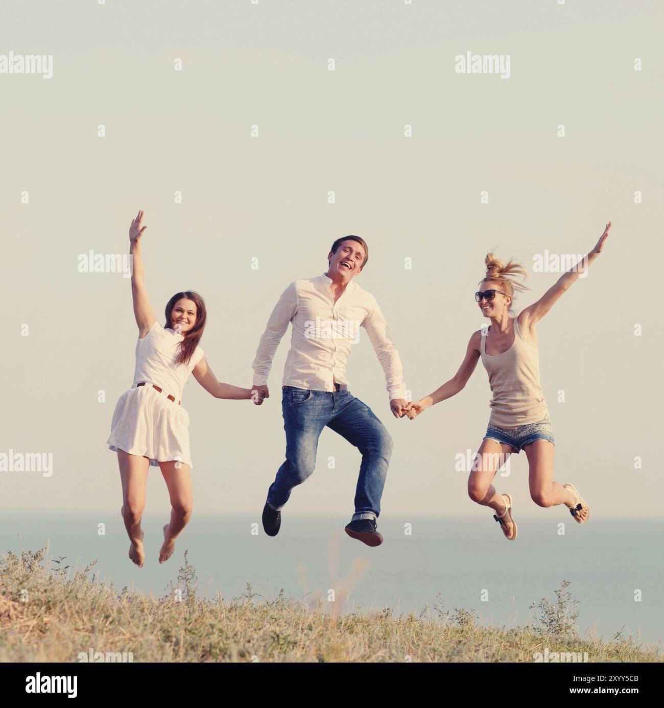 Female friends jumping beach hi-res stock photography and images - Alamy