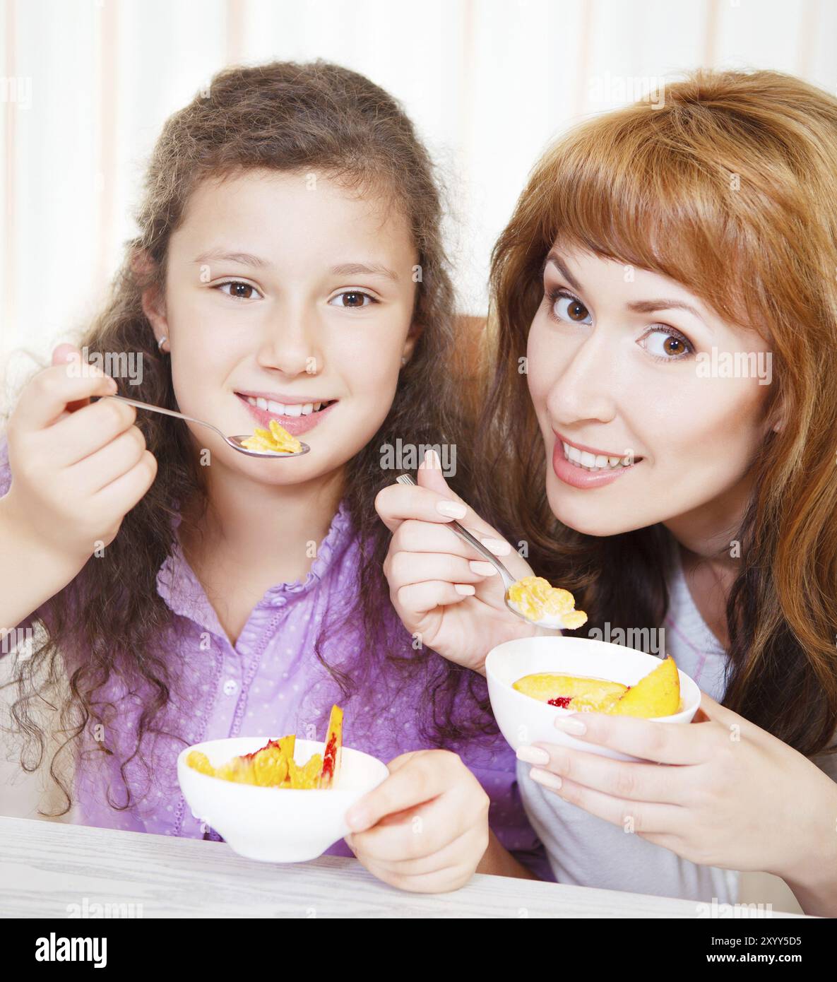Mother daughter happily share breakfast hi-res stock photography and ...