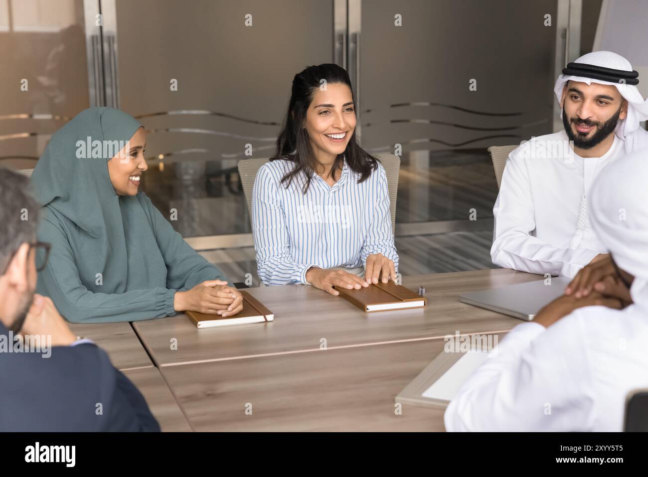 Cheerful multiethnic Arabian and European coworkers having fun Stock ...