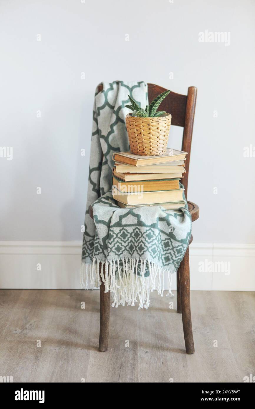Interior with old chair with books Stock Photo - Alamy
