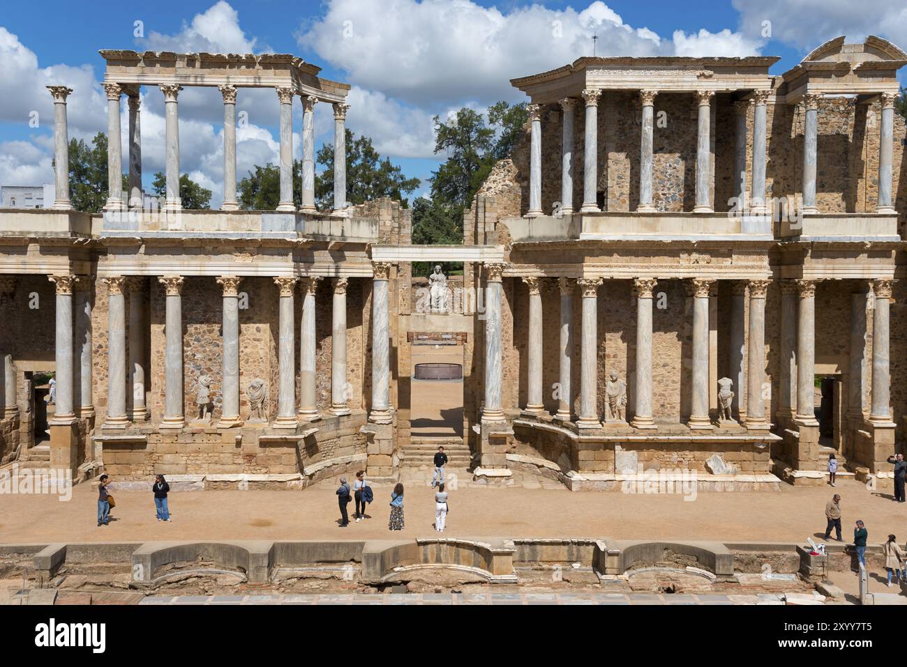 Front view of an ancient Roman building with columns, people exploring ...