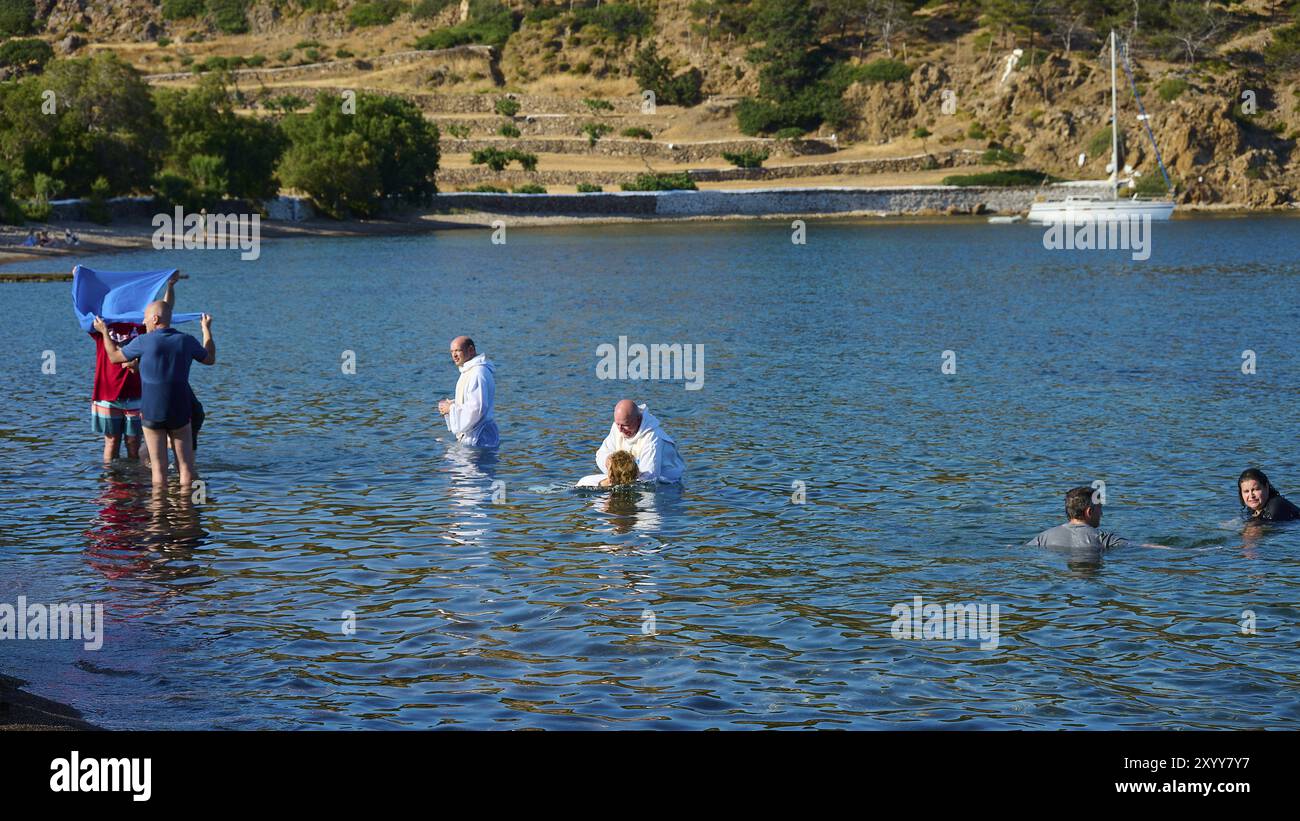 Men in white clothes and swimming costumes in the water during a ...