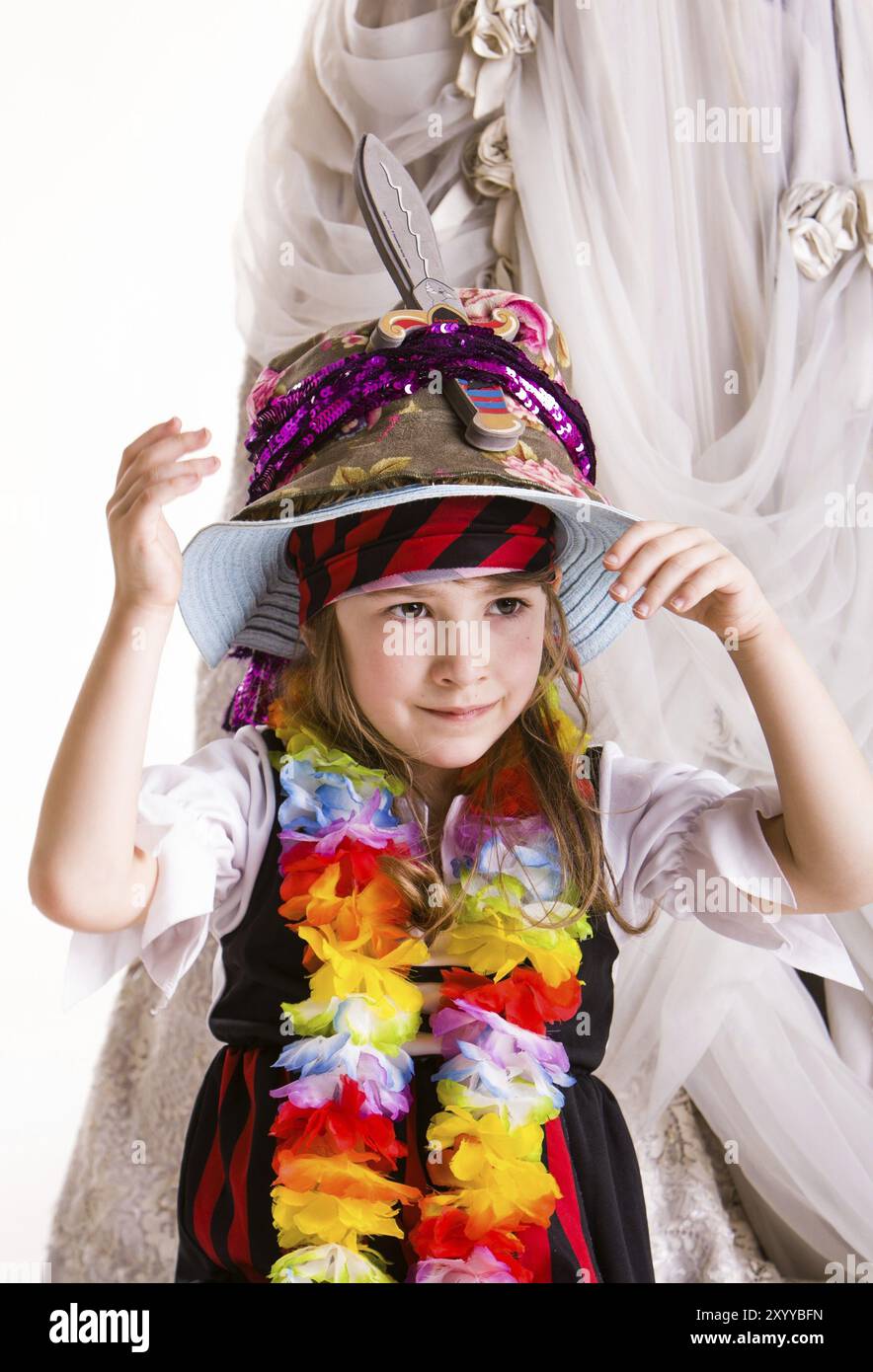 Little girl dressing up with a pile of hats Stock Photo - Alamy