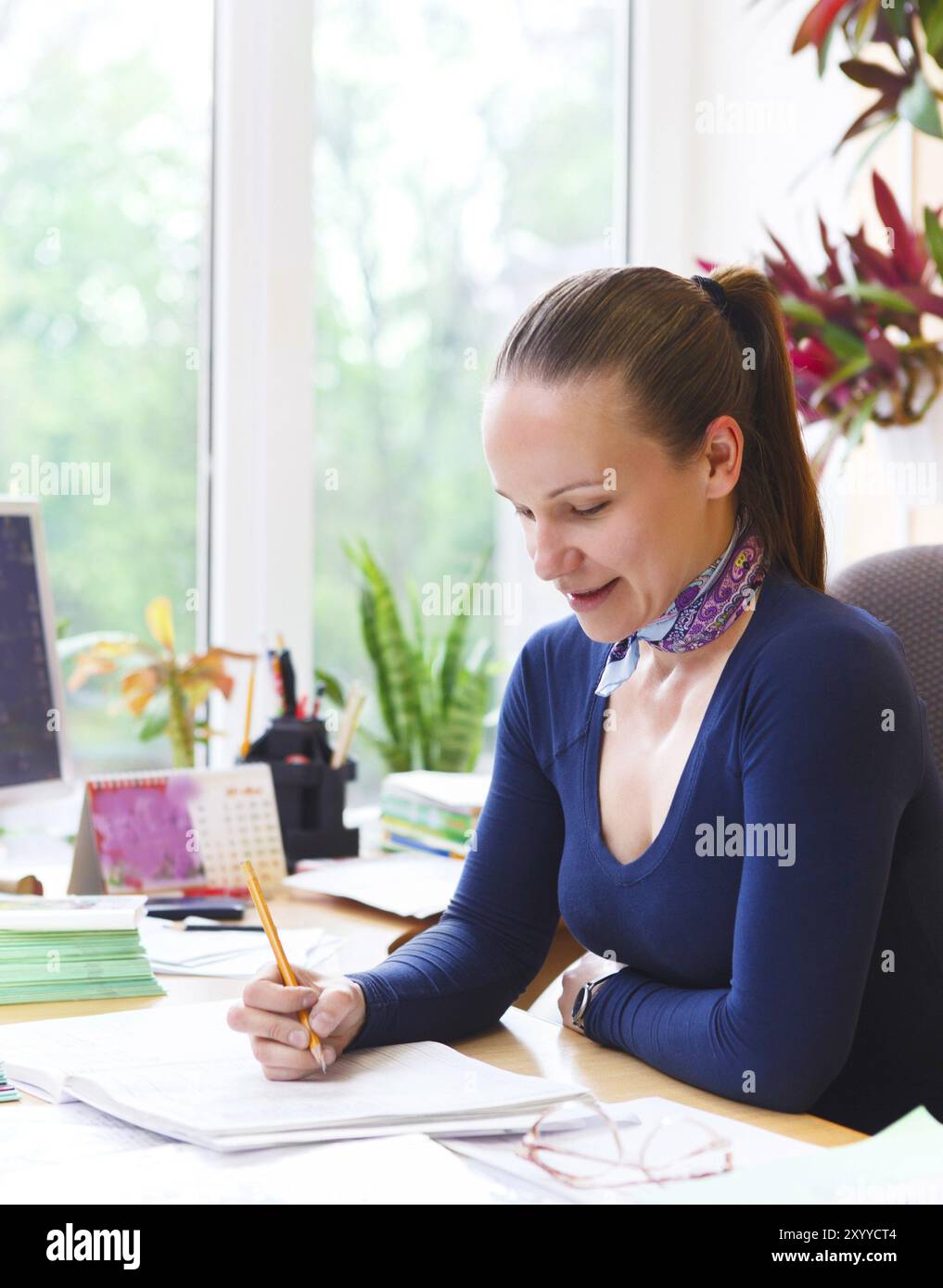 Young female teacher marking hi-res stock photography and images - Alamy