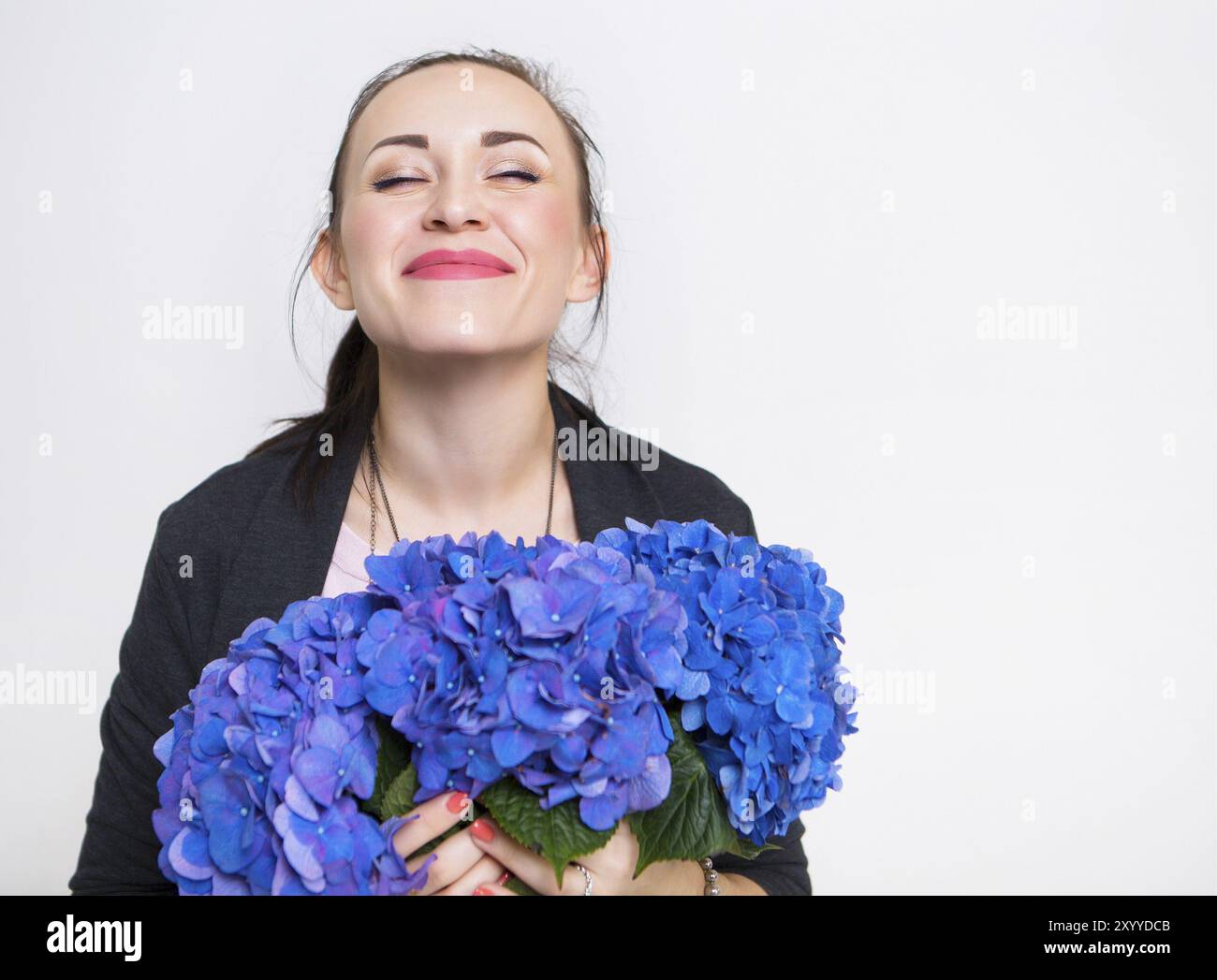 Pretty funny woman with indoors hydrangea on white background Stock ...