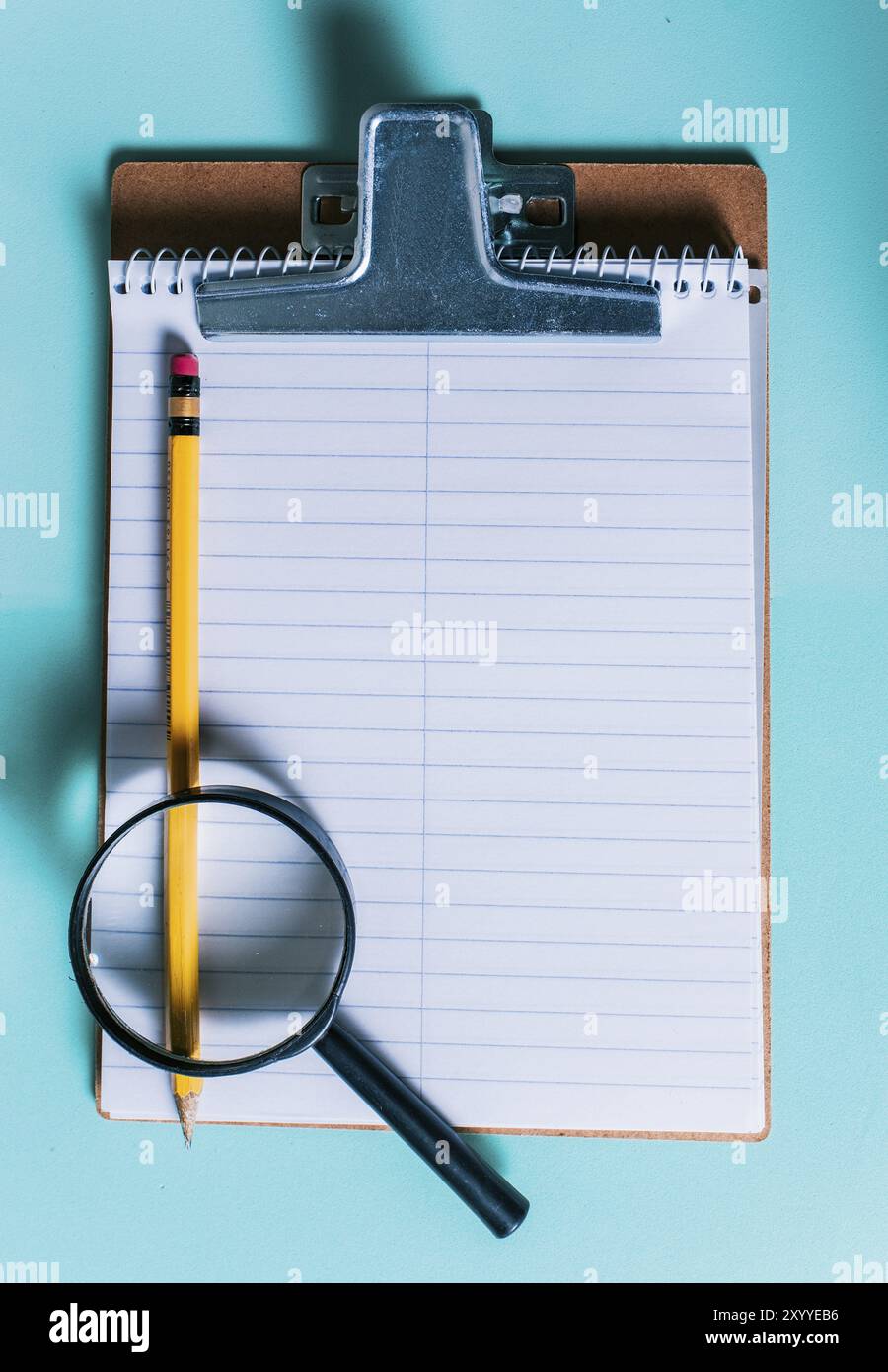 Notepad with pencil and magnifying glass on isolated background. Note ...